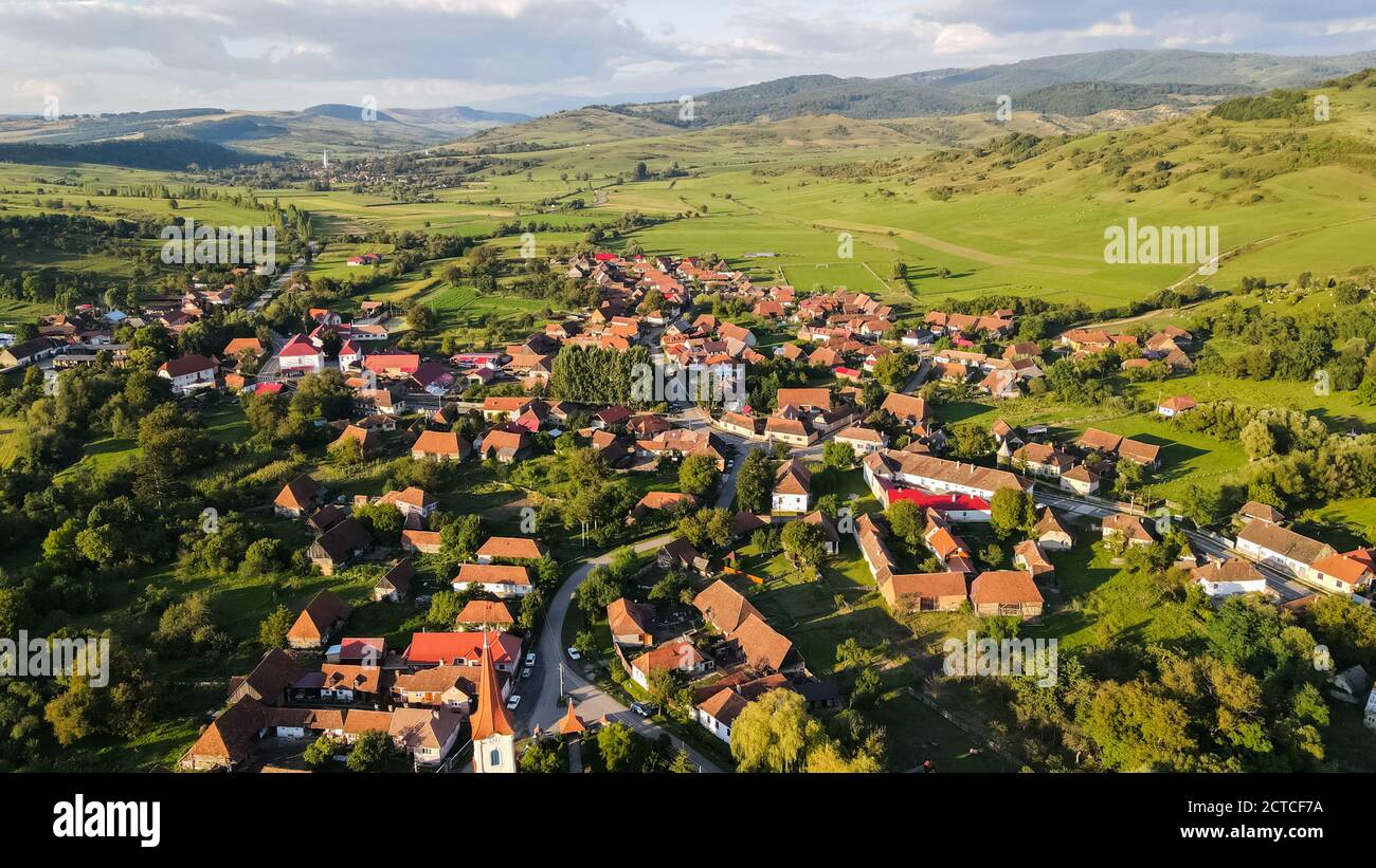 Aerial view of rural Romania, with houses, lakes, green forest and ...