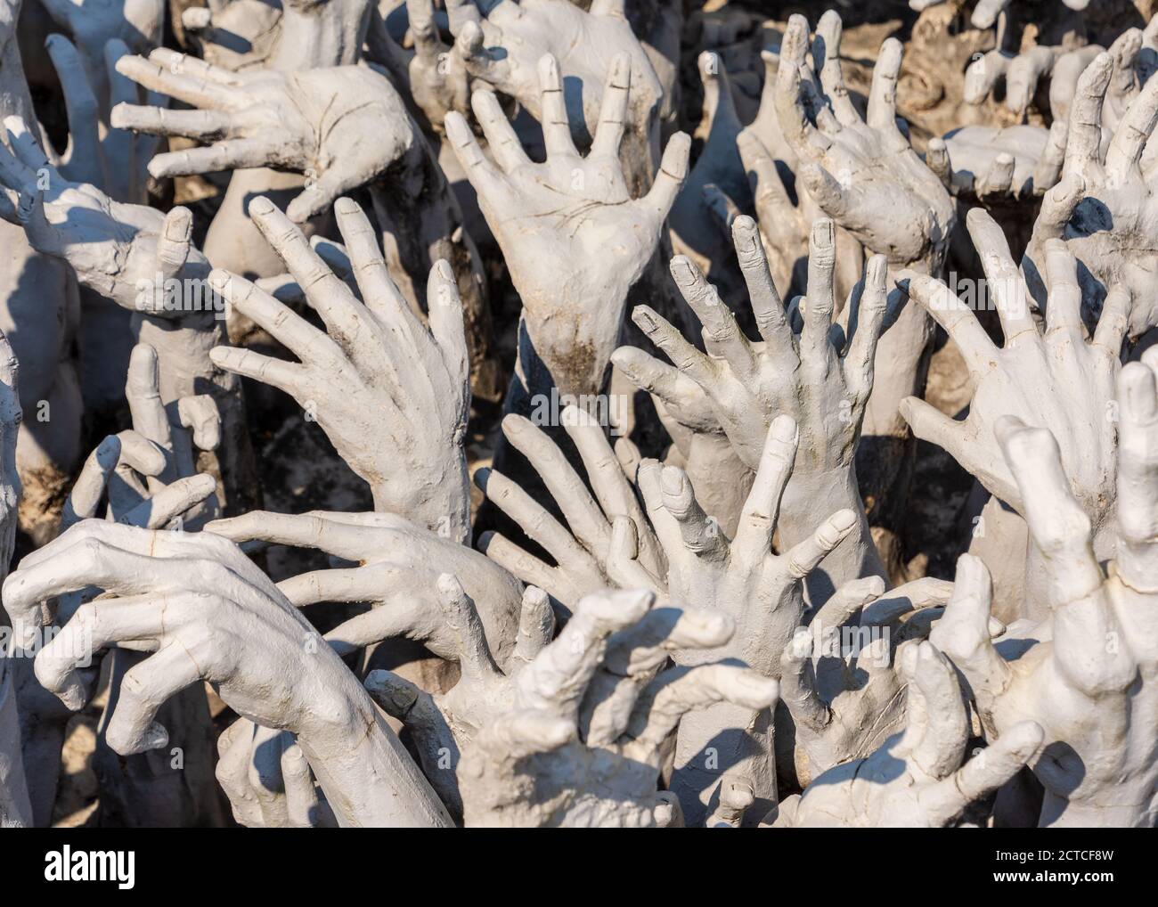 A close up view of hands reaching out of hell at the White Temple (Wat ...