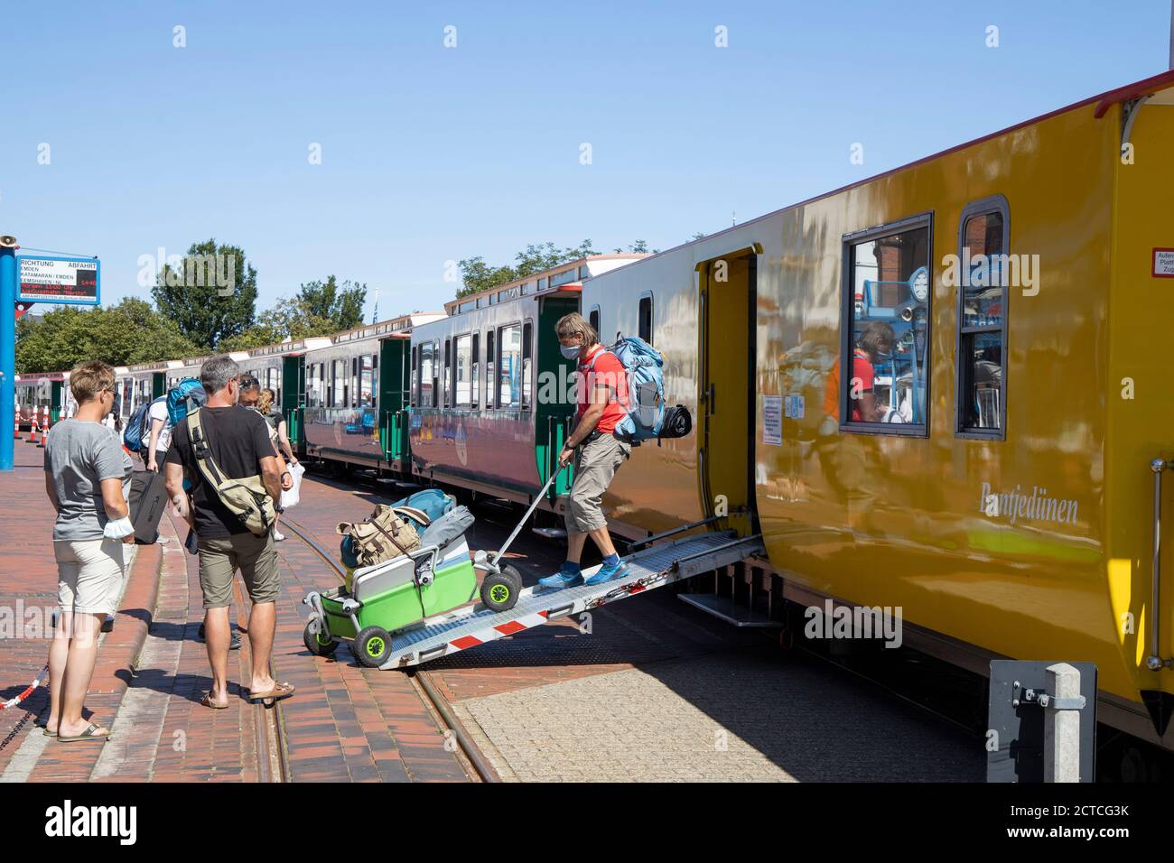 Passengers boarding the Borkum Kleinbahn (narrow gauge train) at the ...
