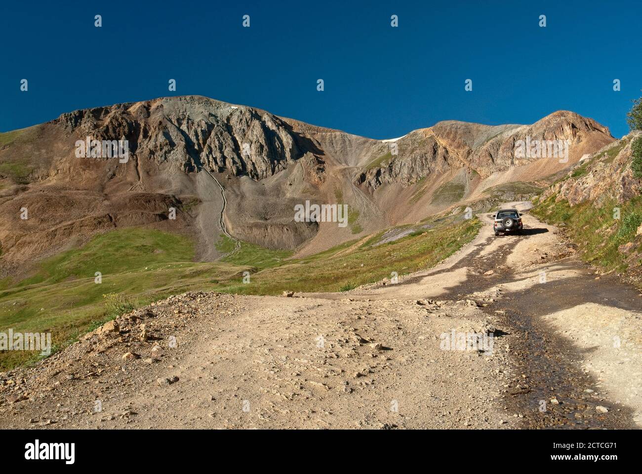 4WD vehicle on Alpine Loop near Cinnamon Pass, Cinnamon Mtn on right ...