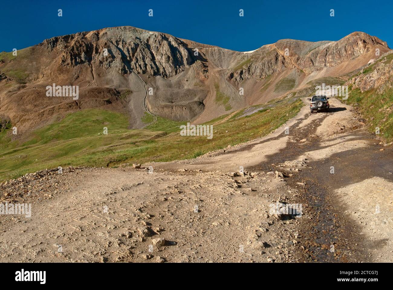 4WD vehicle on Alpine Loop near Cinnamon Pass, Cinnamon Mtn on right ...
