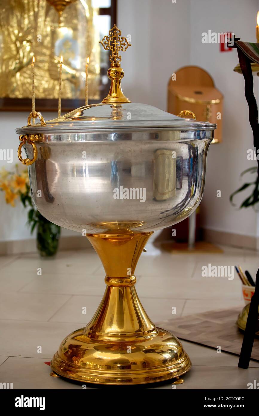 The interior of the church during the baptism of a child. Bath for ...