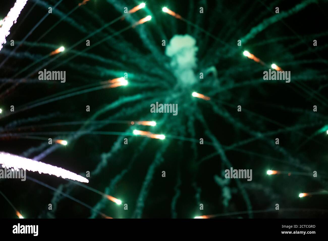 Green rays from the explosion of fireworks with smoke spots Stock Photo ...