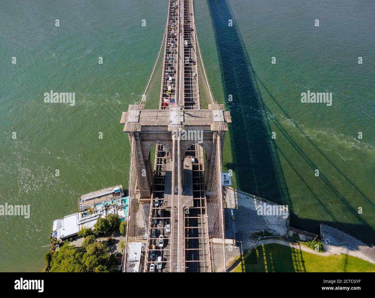 AERIAL flight over Brooklyn Bridge with American flag waving and East ...