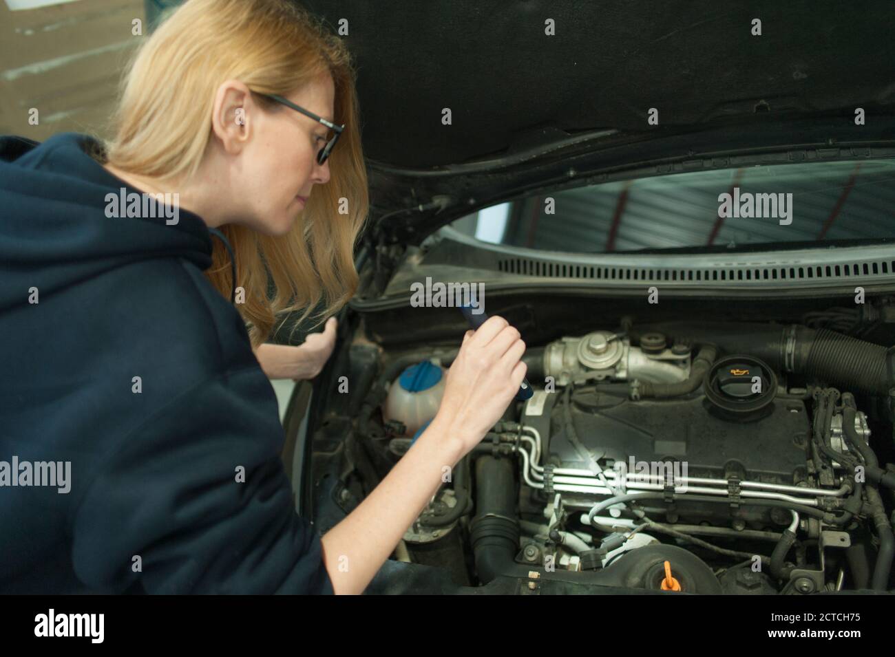 Woman fixing car engine hi-res stock photography and images - Alamy