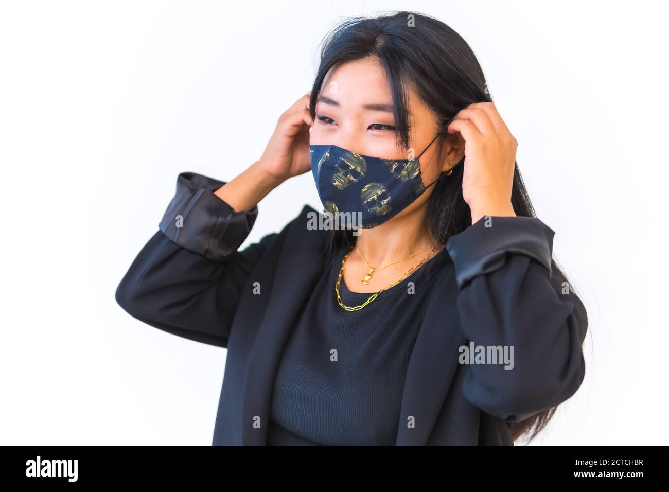 Closeup of a beautiful Chinese woman wearing a patterned face mask in ...