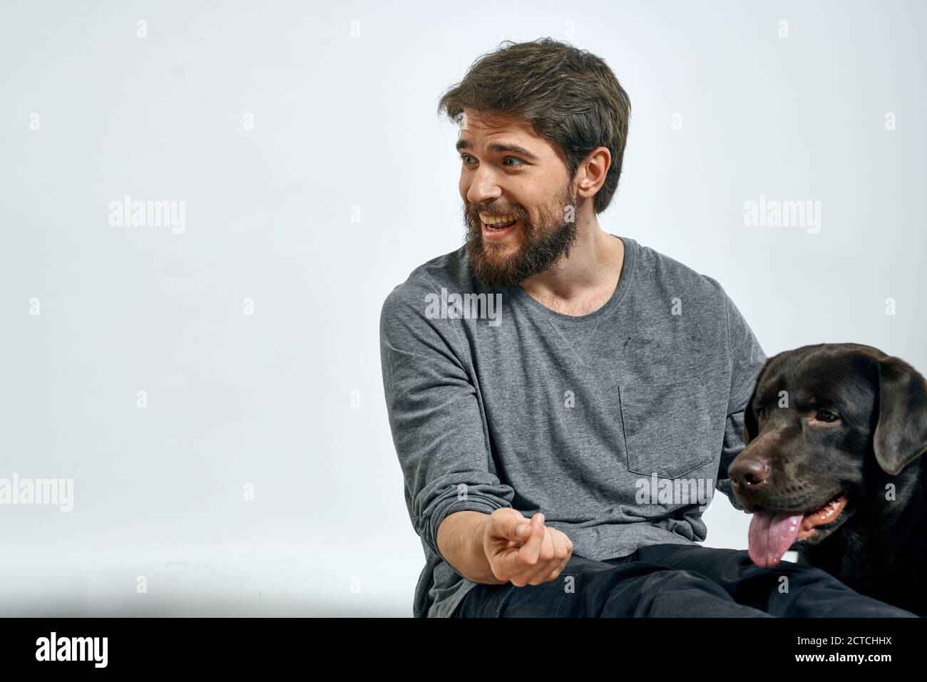 happy owner with pet black dog training model emotions Stock Photo - Alamy