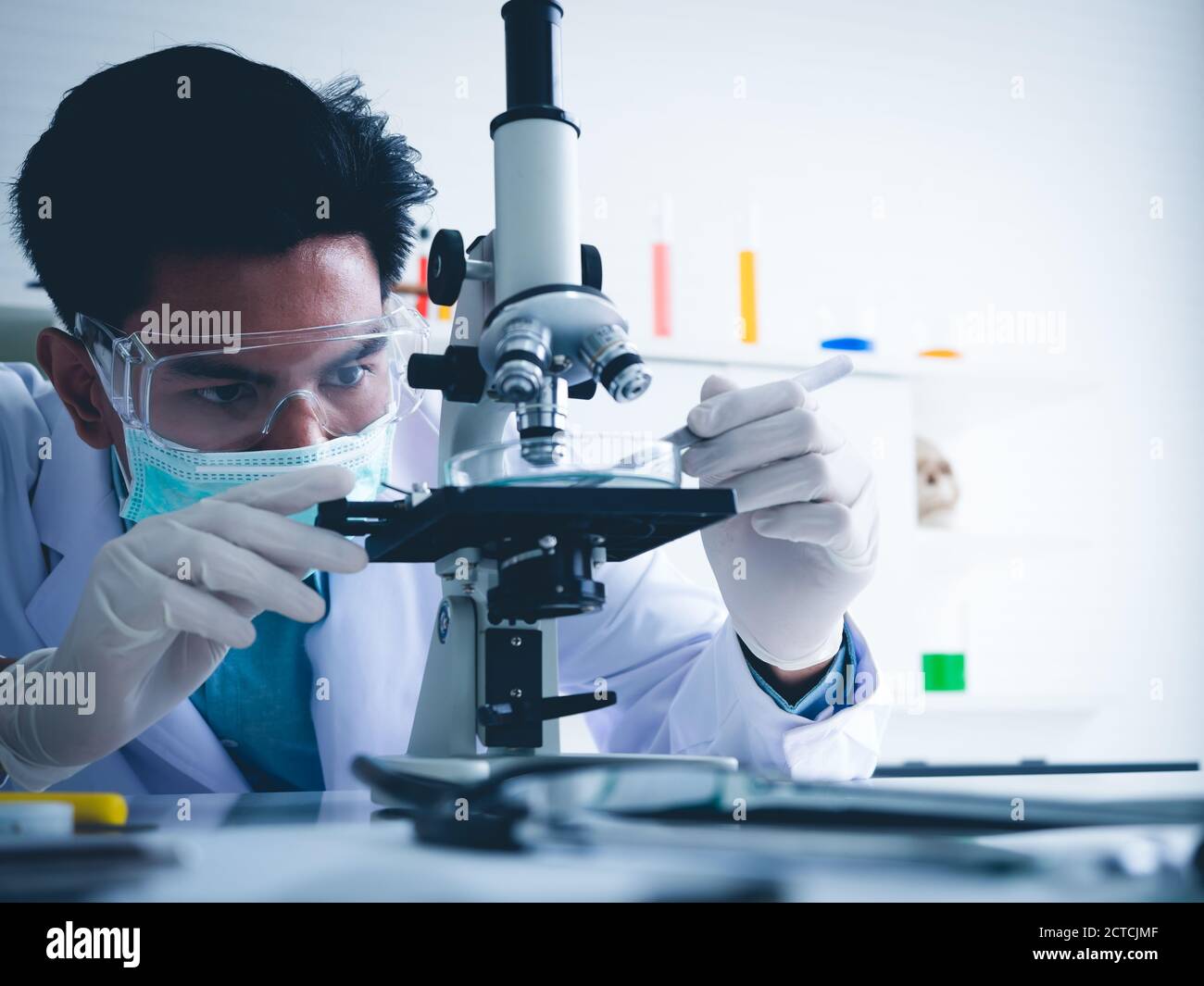 Asian male scientist Is working seriously Chemistry experiment With a ...