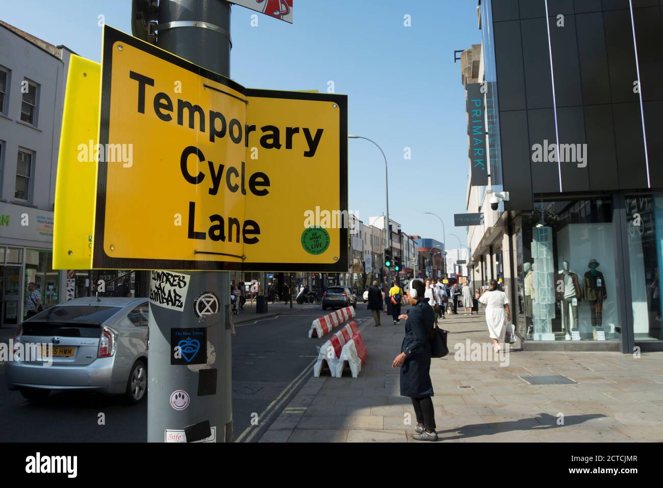 yellow and black temporary cycle lane sign on the busy king street in ...