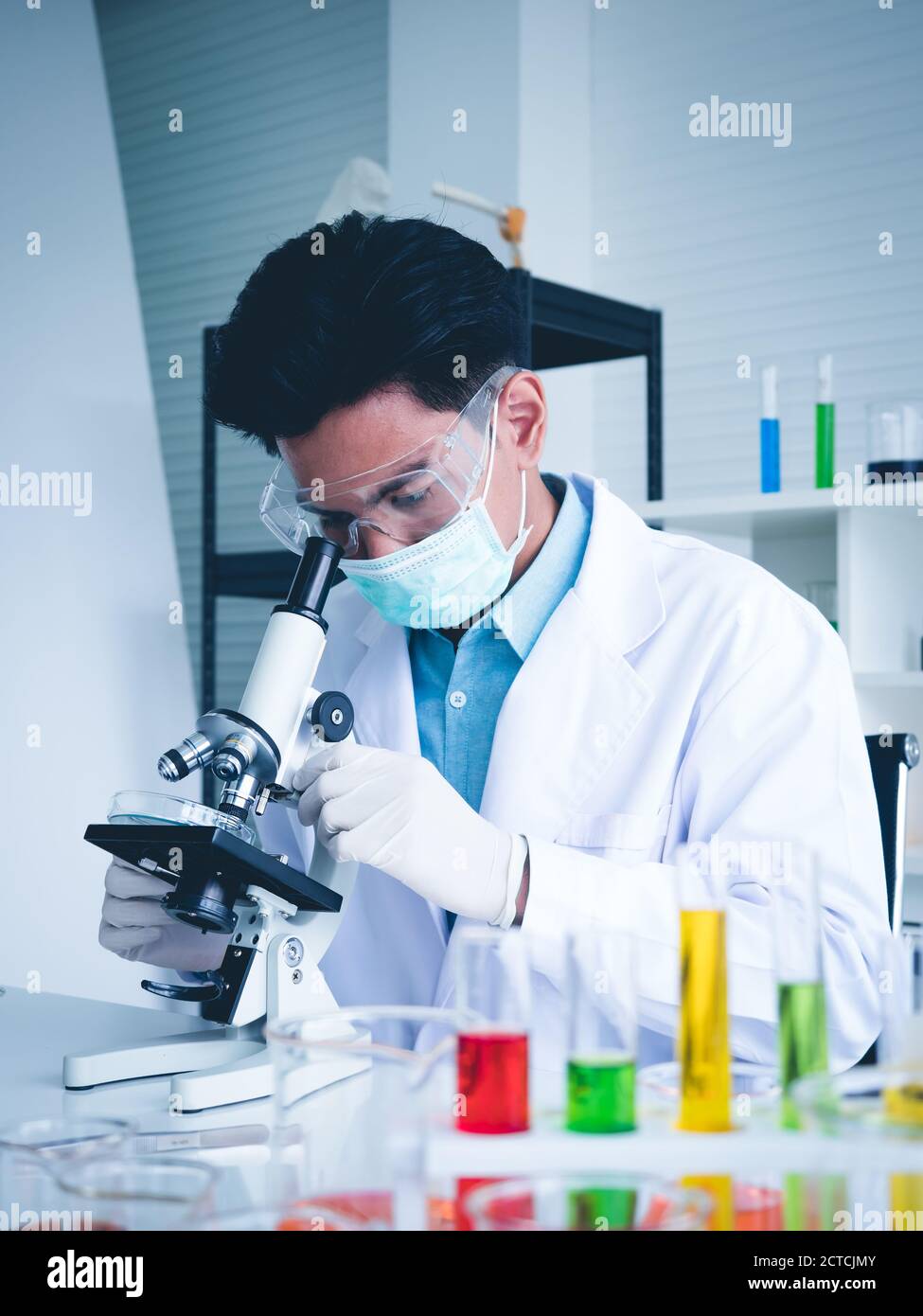 Asian male scientist Is working seriously Chemistry experiment With ...