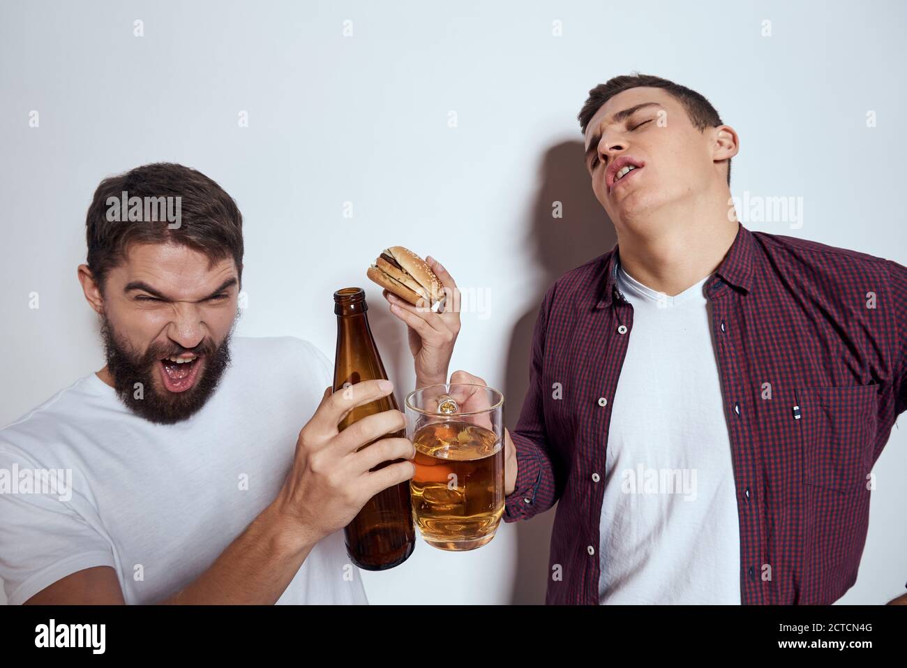 Two friends drink beer leisure fun alcohol friendship lifestyle light ...