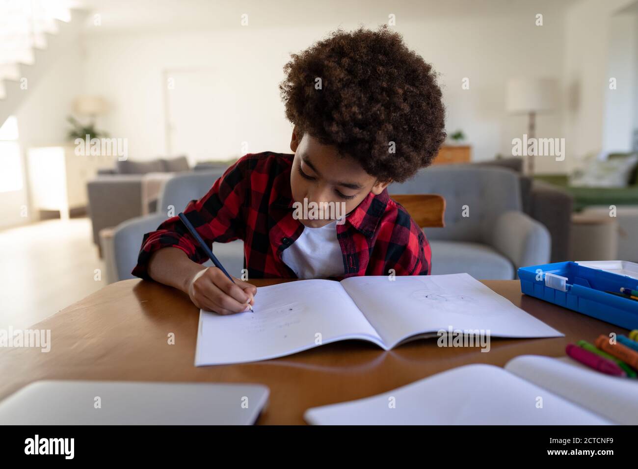 Boy doing homework at home Stock Photo - Alamy