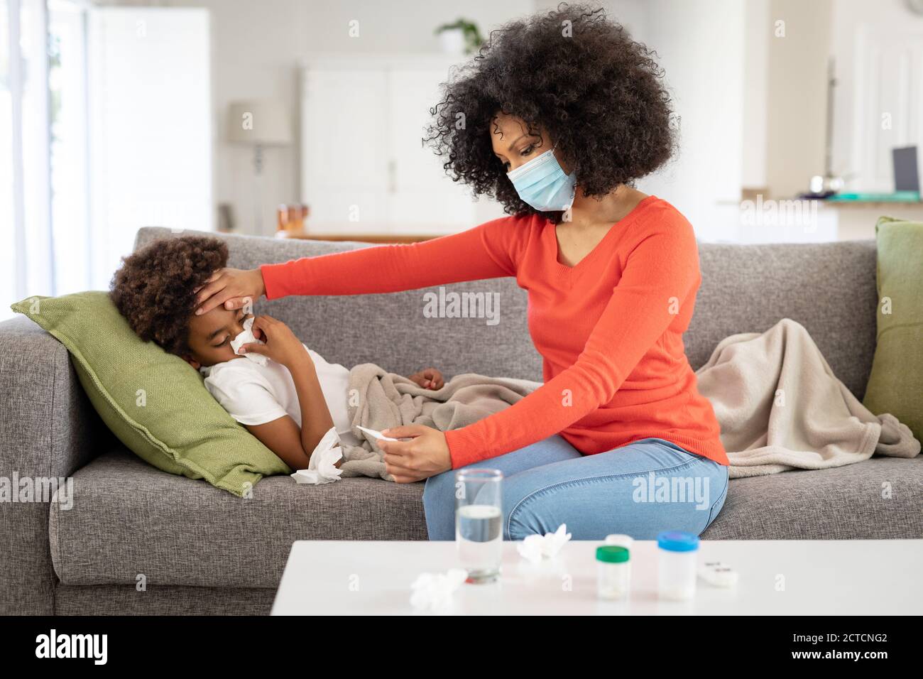 Mother taking care of her sick son at home Stock Photo - Alamy