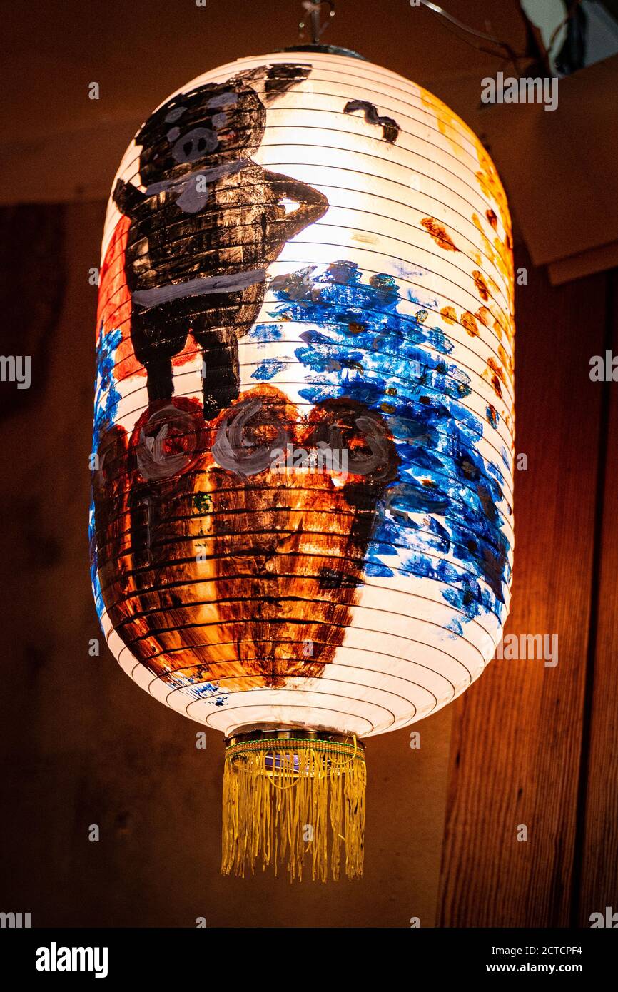 August 12 2019: Lantern hung up in street in Tainan. With some graffti ...