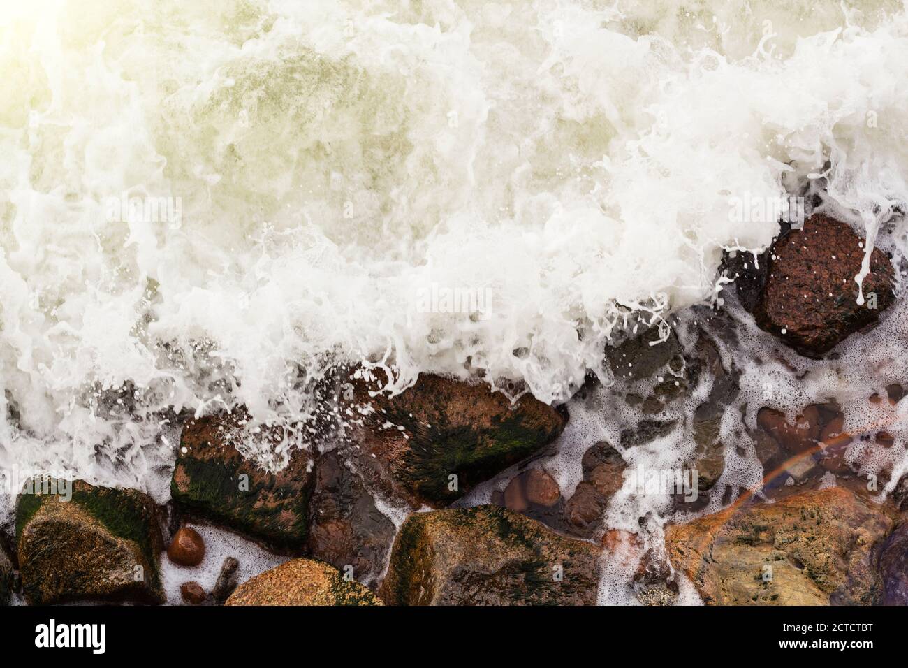 Aerial top view of sea waves hitting rocks Stock Photo - Alamy