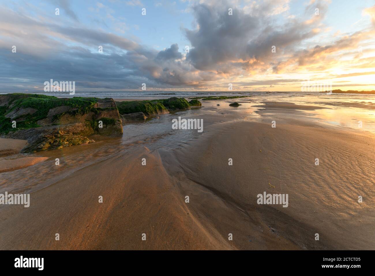 Sunset at the atlantic Ocean with orange beach and sky in France Stock ...