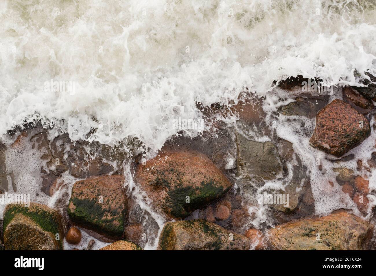 Aerial top view of sea waves hitting rocks Stock Photo - Alamy