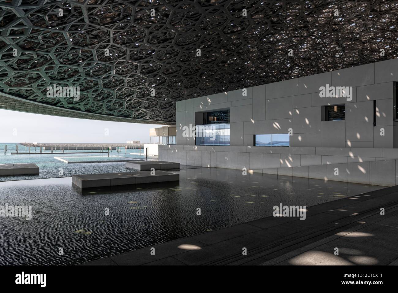 A shot from the interior of the Louvre Abu Dhabi at the waters edge ...