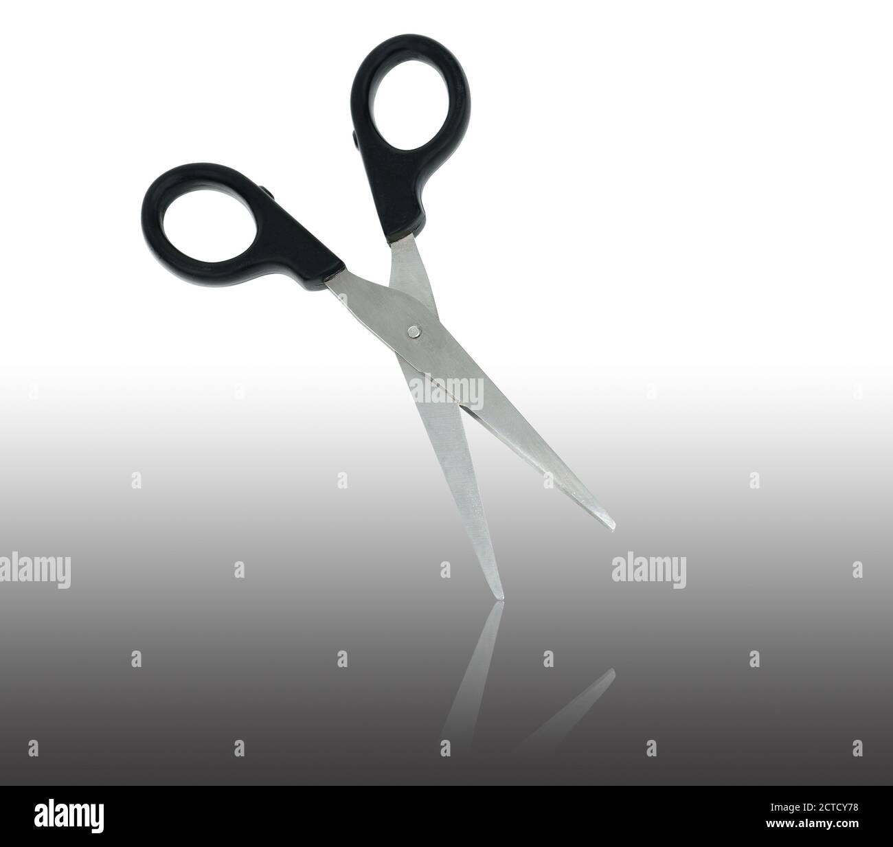 scissors with black handle and mirror reflection on a white background ...