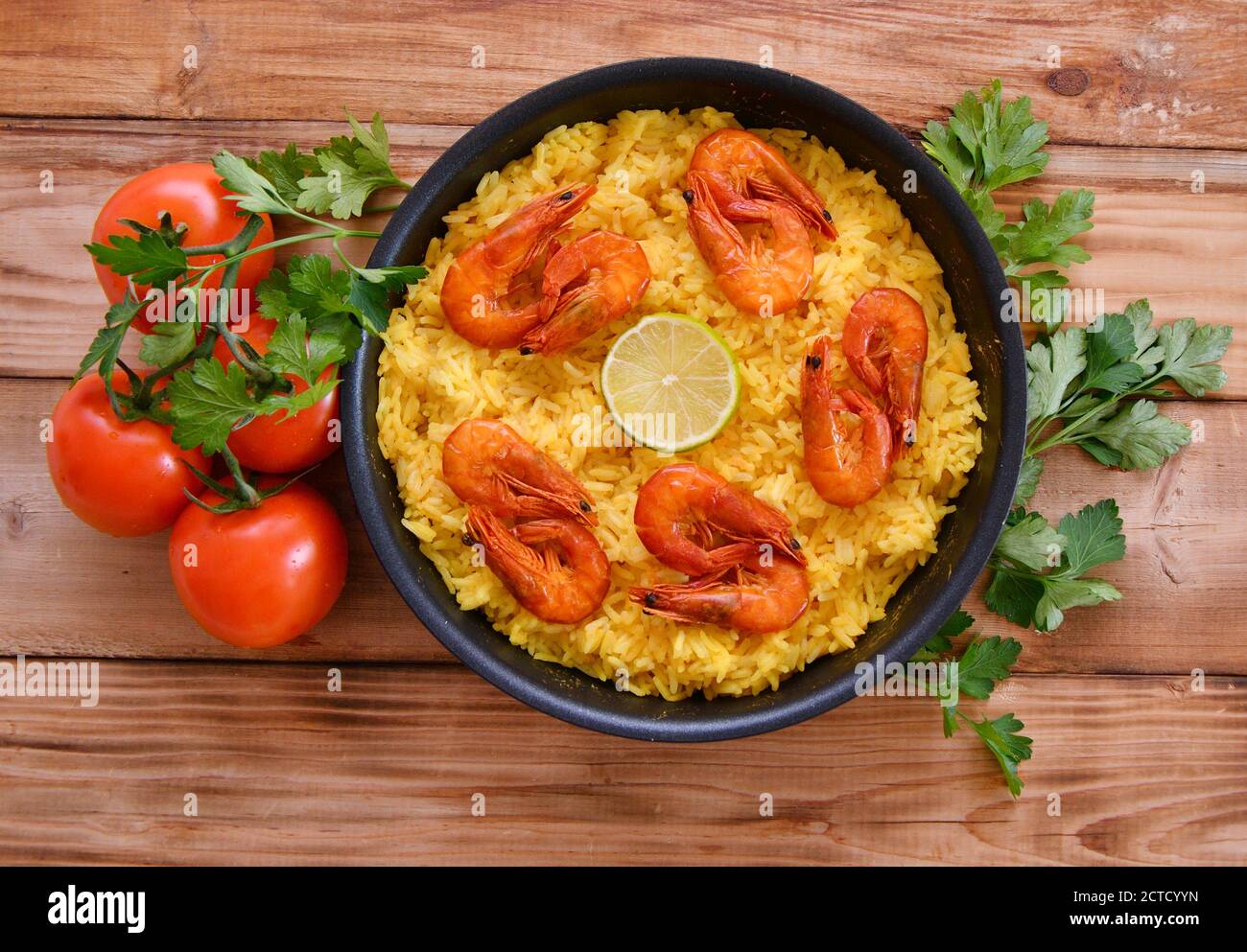 Rice paella with shrimp, saffron and olive oil - Spanish national dish ...