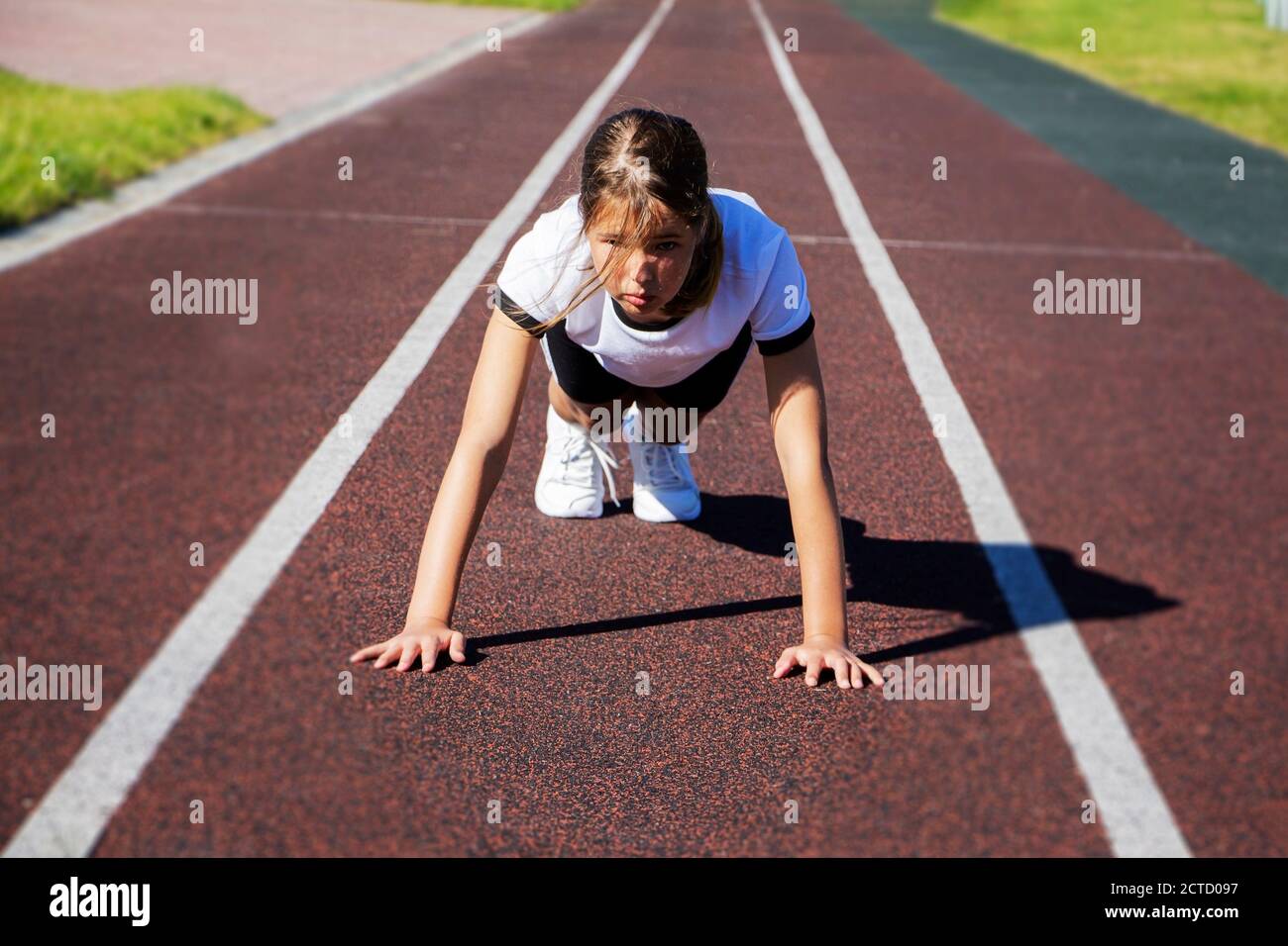 a teenage girl does push-UPS on the Playground. Fitness, sports, health ...
