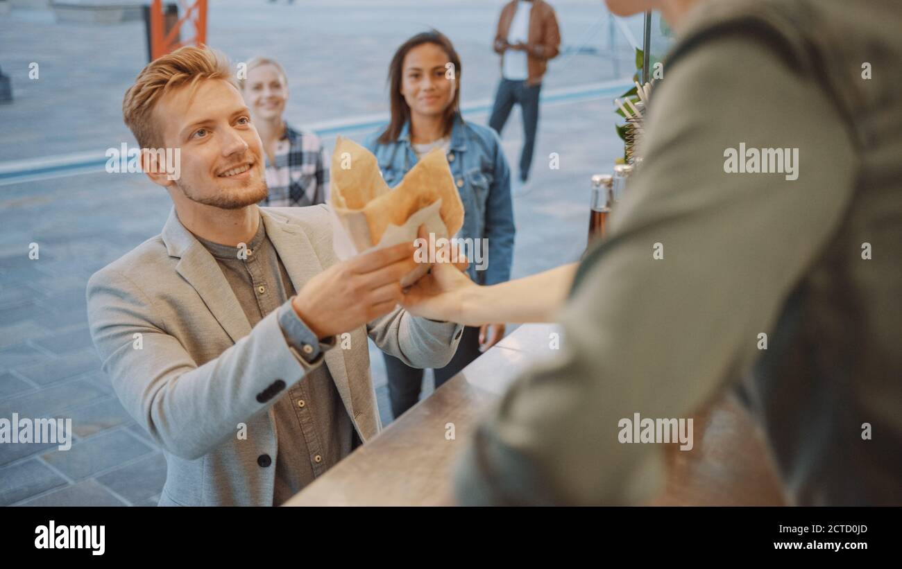 Hands taking a hamburger hi-res stock photography and images - Alamy