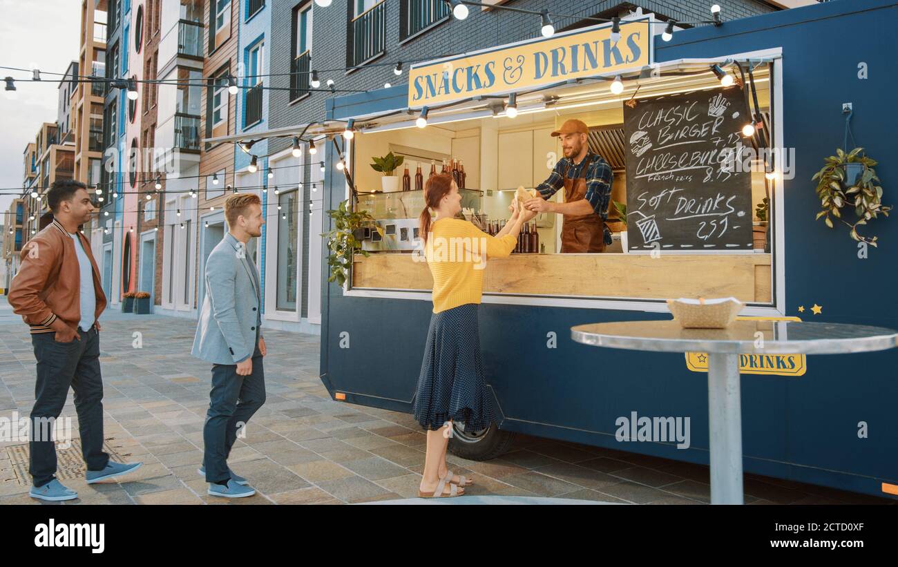 Food Truck Employee Hands Out a Freshly Made Gourmet Burgers to a Happy ...