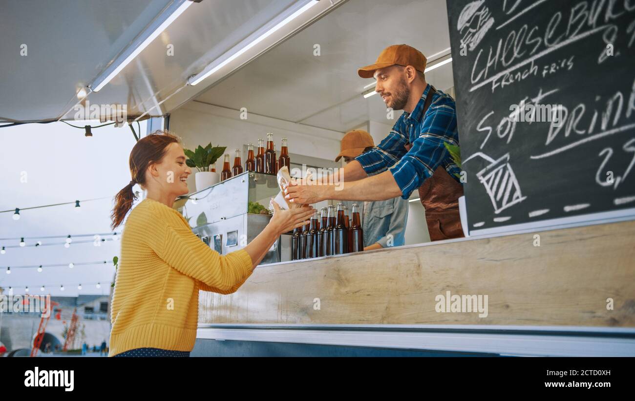 Food Truck Employee Hands Out a Freshly Made Gourmet Burger to a Happy ...
