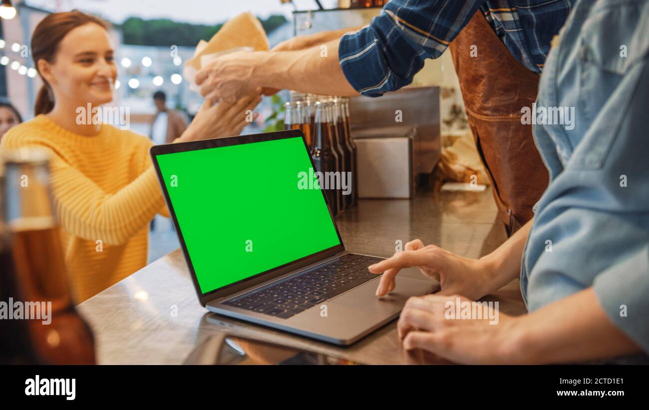 Laptop Computer with Green Screen Mock Up Screen is Placed on a Counter ...