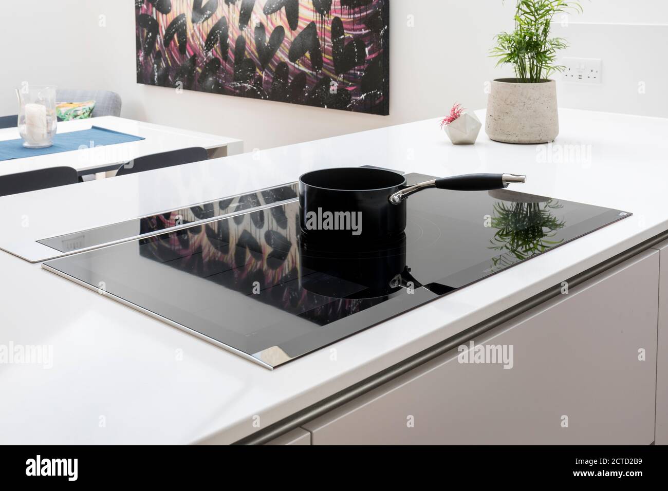 Modern kitchen detail with white units and built in induction hob Stock ...