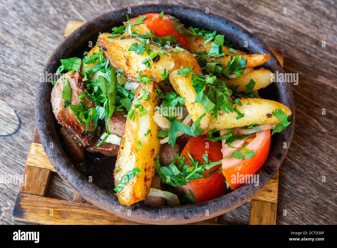 Georgian odjakhuri dish of meat with potatoes and salad Stock Photo - Alamy