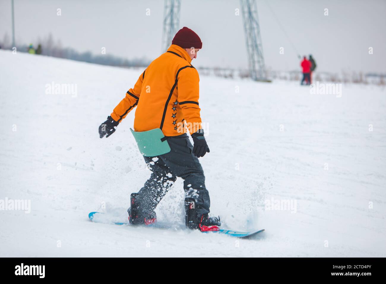 man snowboarding down by hill Stock Photo - Alamy