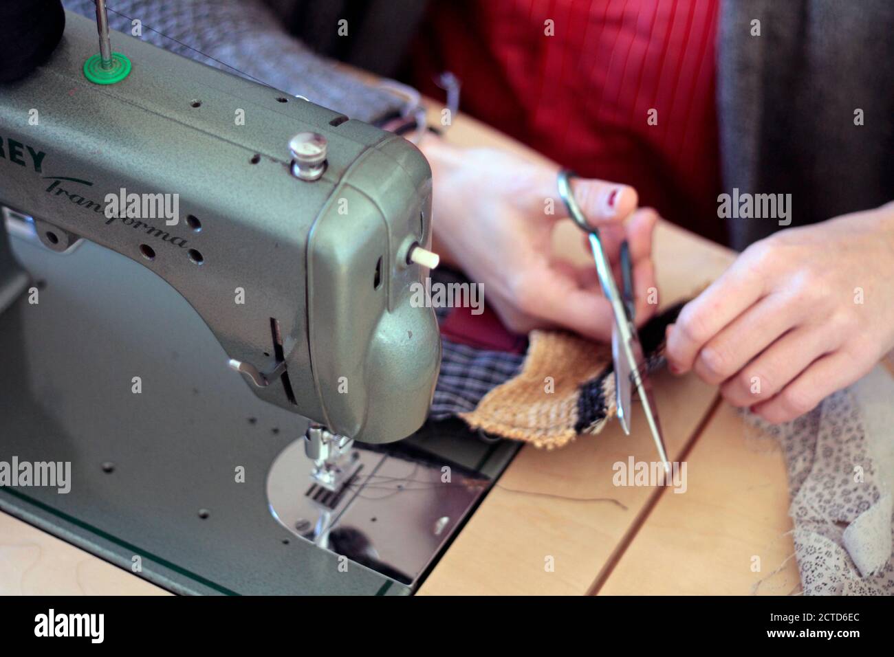 Sewing with machine. Detail of tailor hand working with fabric Stock ...