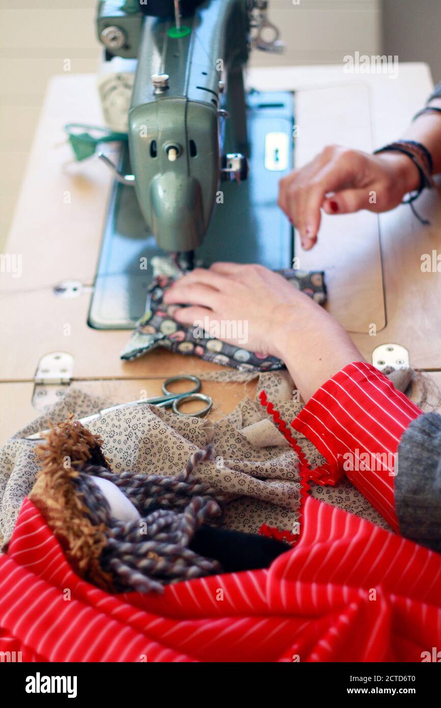 Sewing with machine. Detail of tailor hand working with fabric Stock ...