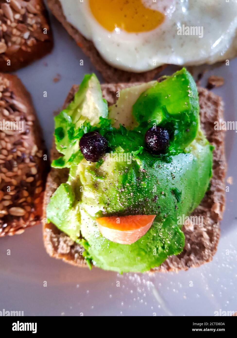 Vegetable face on a white plate Stock Photo - Alamy