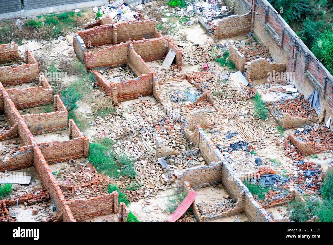 Aerial drone shot of broken demolished brickwork houses with fallen ...
