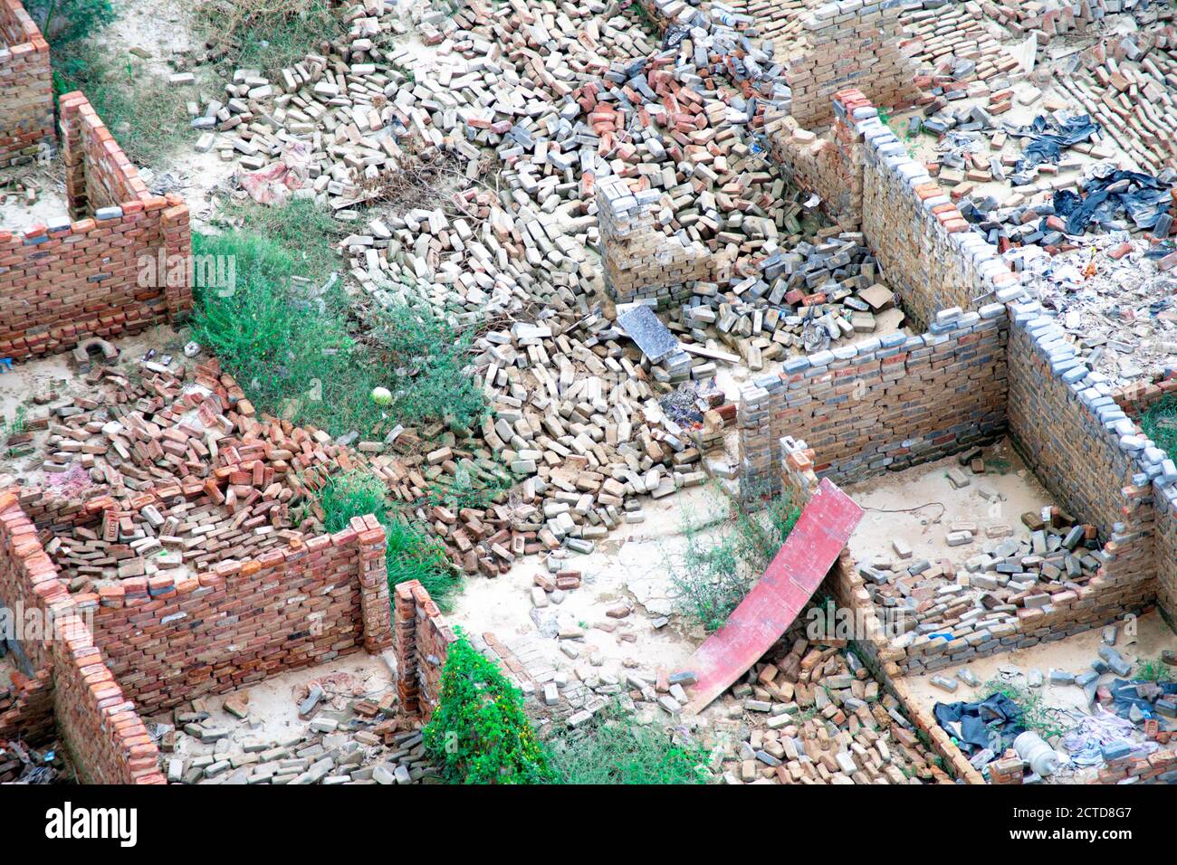 Aerial drone shot of broken demolished brickwork houses with fallen ...