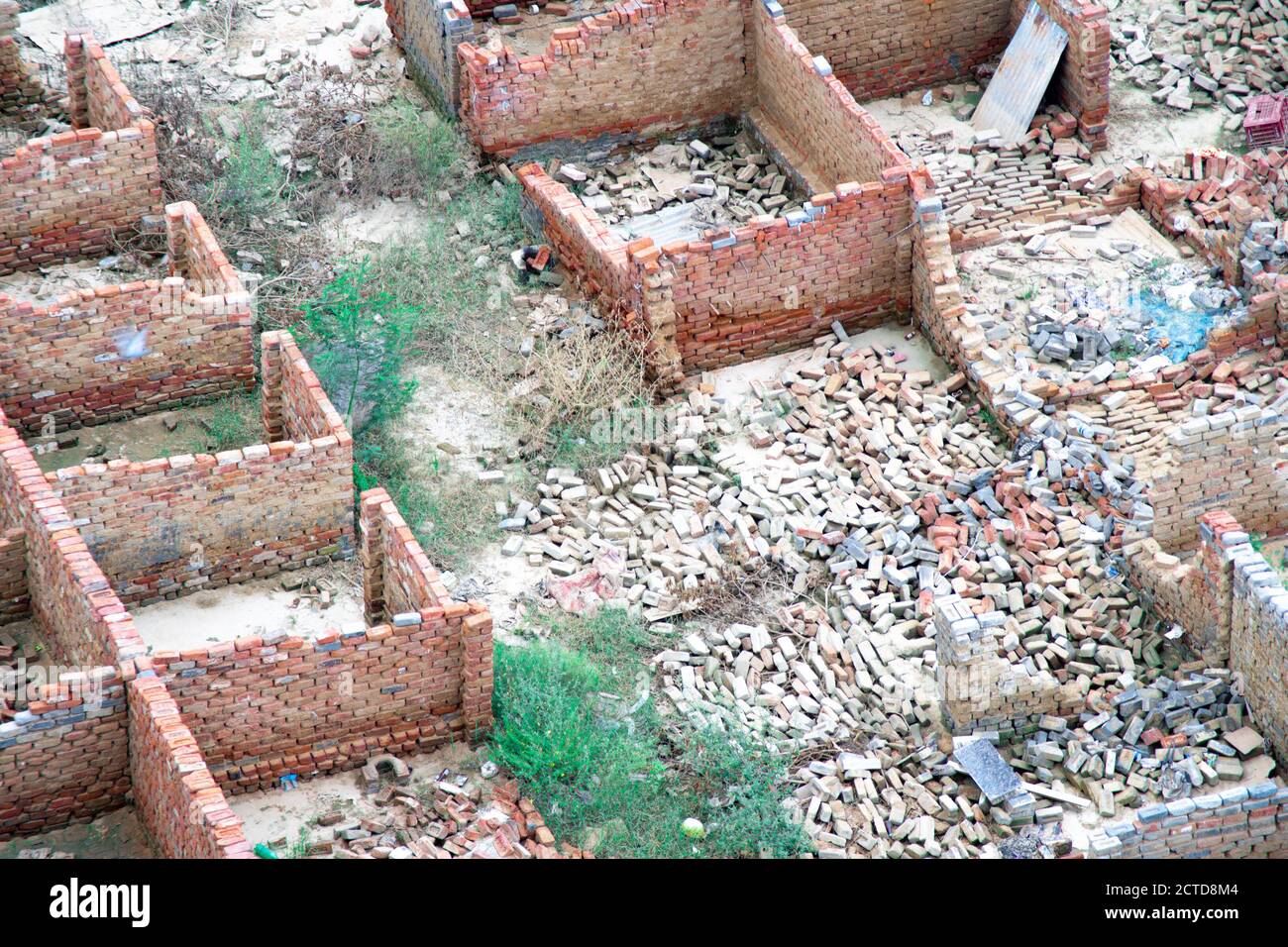 Aerial drone shot of broken demolished brickwork houses with fallen ...