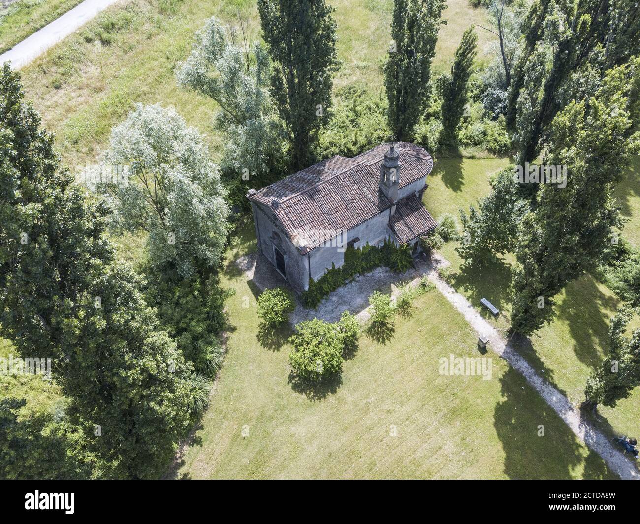 An aerial shot of a residential plot with a large house surrounded by ...