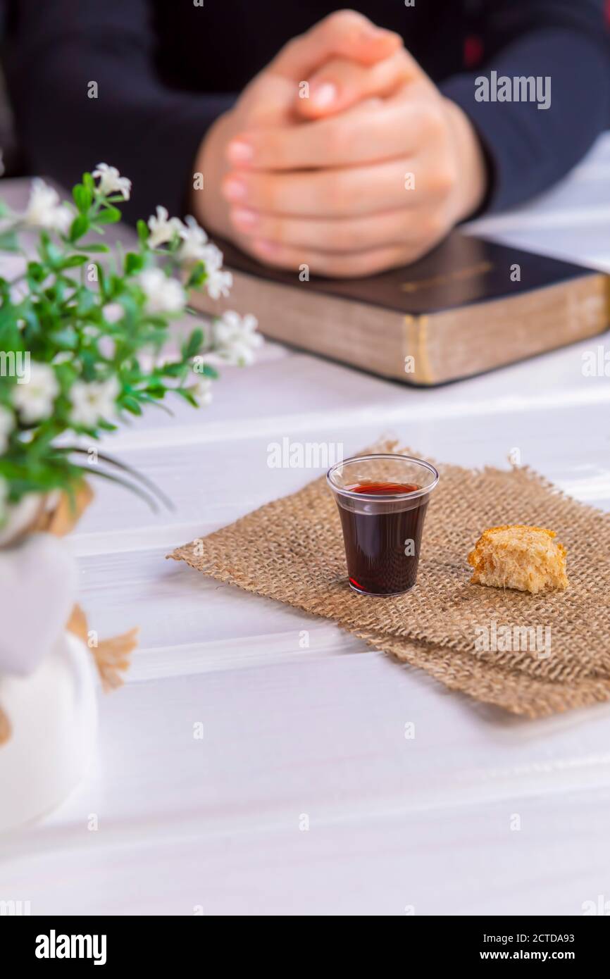 Young woman praying and Taking communion - the wine and the bread ...