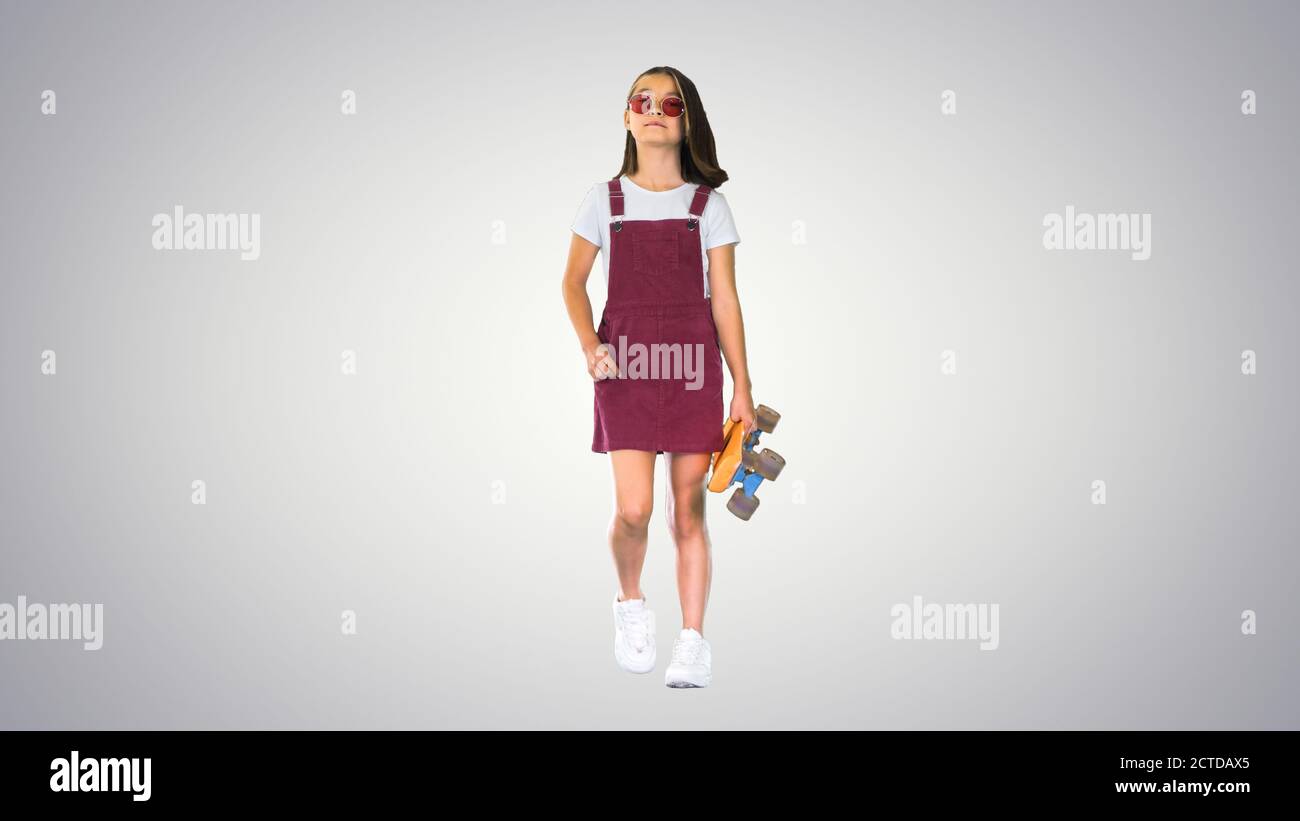 Too-cool-for-school Asian skater girl walking on gradient backgr Stock ...