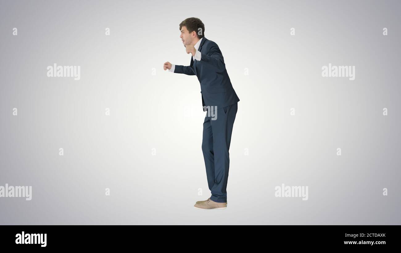 Arrogant businessman in a suit dancing on gradient background Stock ...