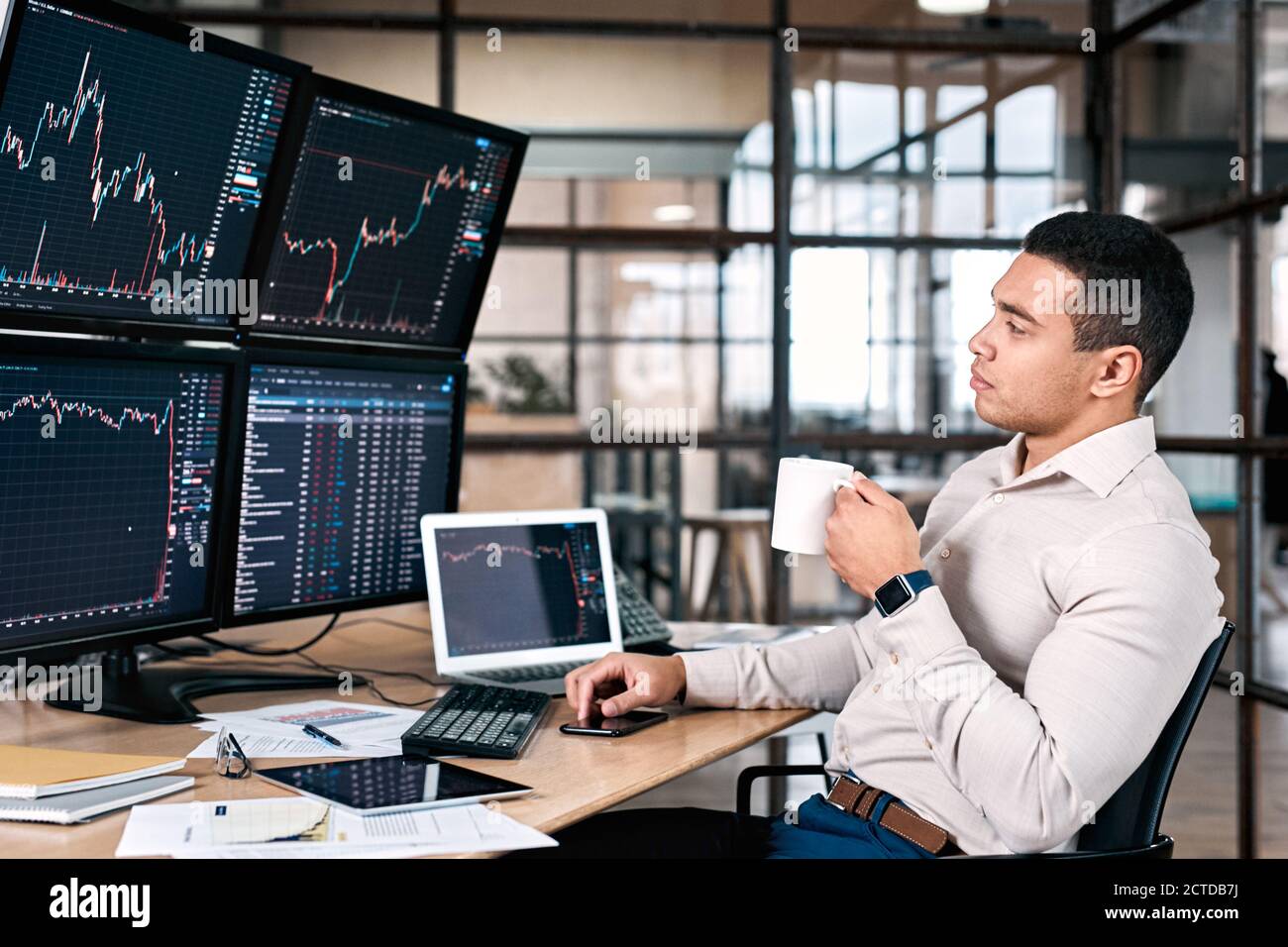 Stock trader analyzing stat and dynamic on forex charts and drinking ...