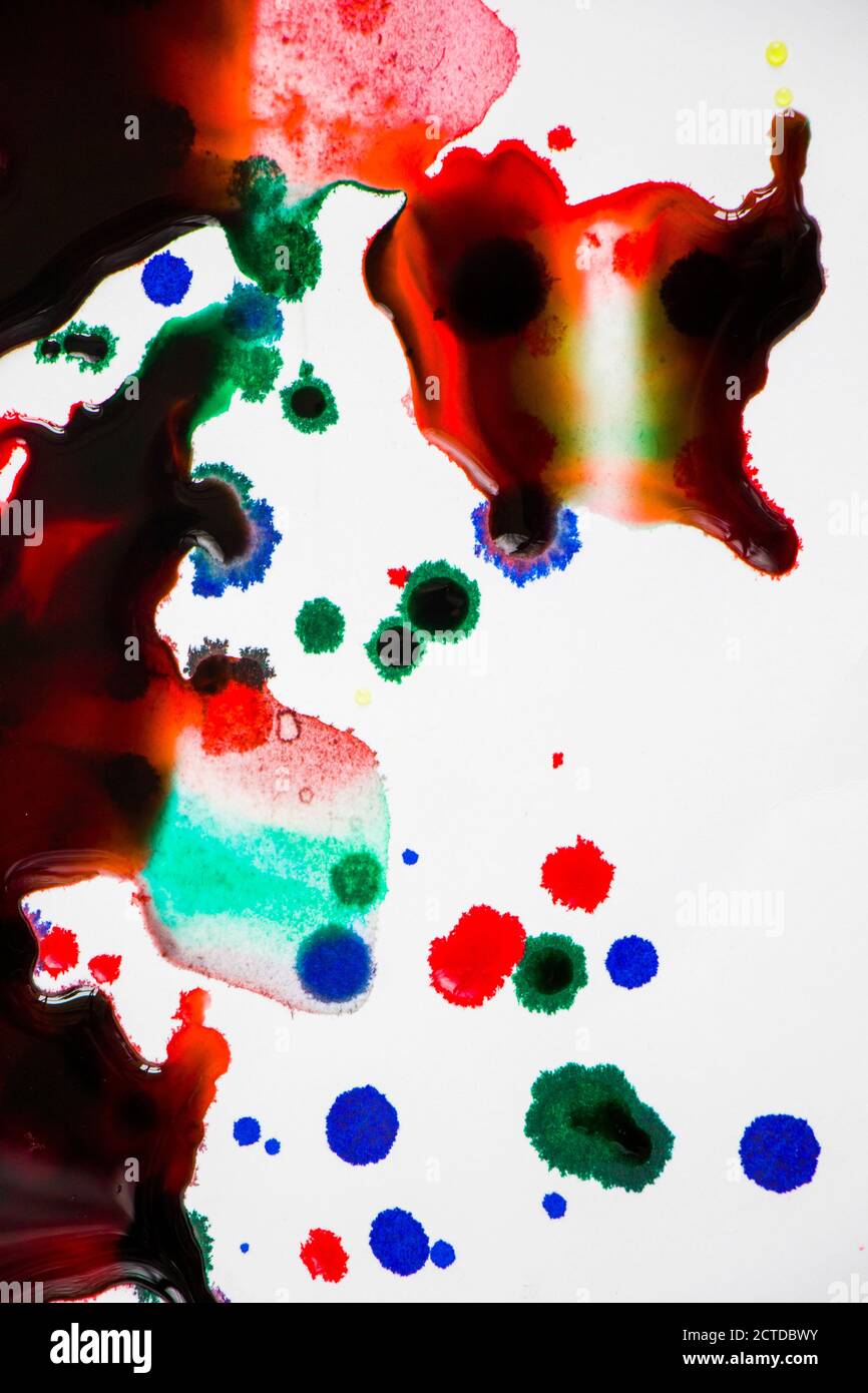 Ink drops on the paper, red, green and blue ink splashes background ...
