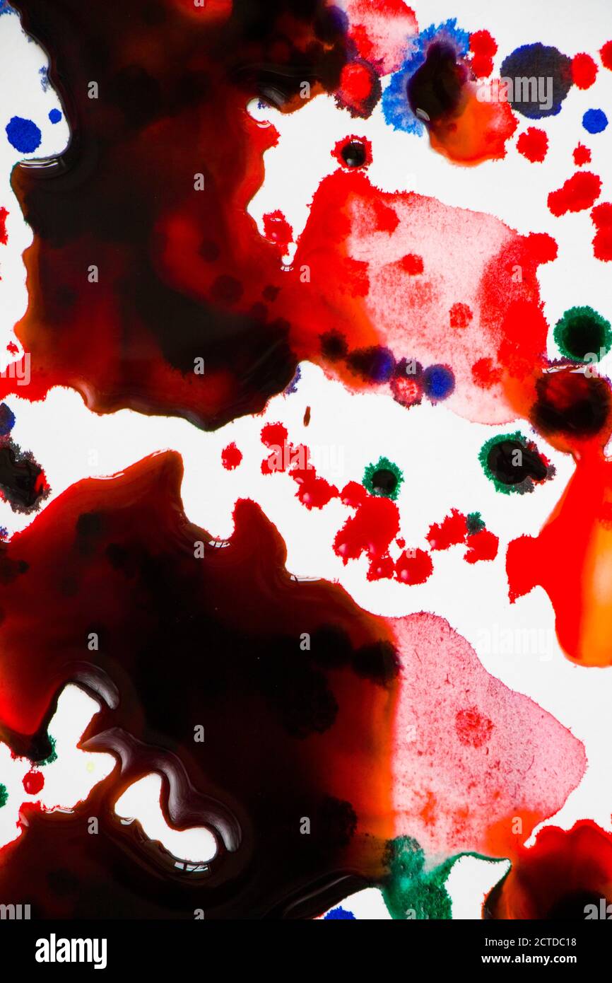 Ink drops on the paper, red, green and blue ink splashes background ...