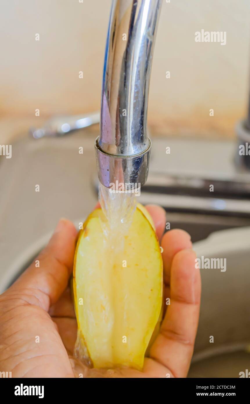 Washing Starfruit With Running Water Stock Photo - Alamy