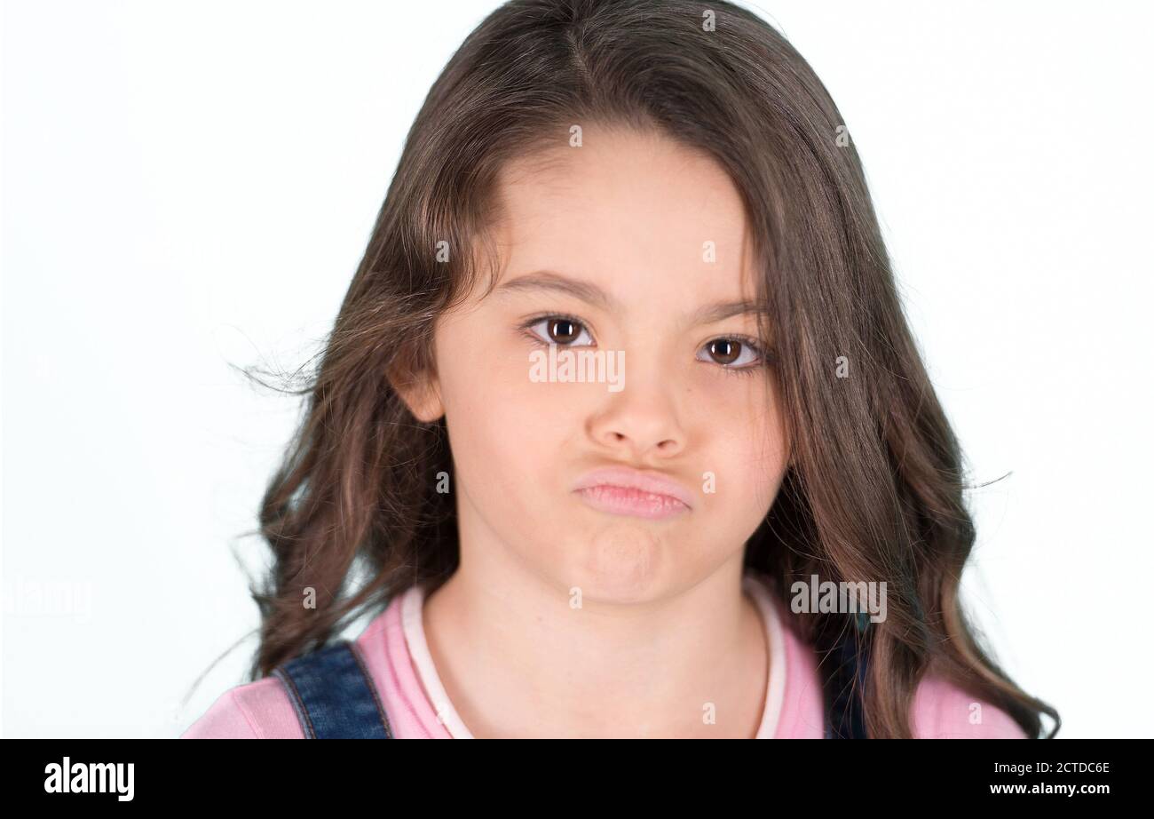 Beautiful girl looking sad with pouted lips. Cute kid with long hair ...