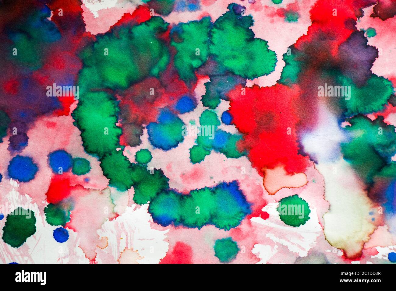 Ink drops on the paper, red, green and blue ink splashes background ...