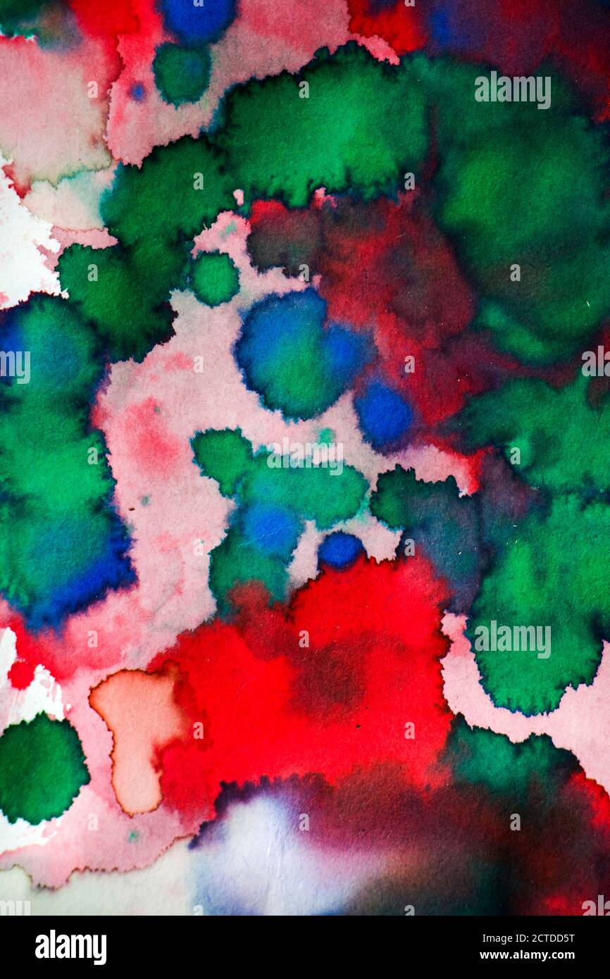 Ink drops on the paper, red, green and blue ink splashes background ...