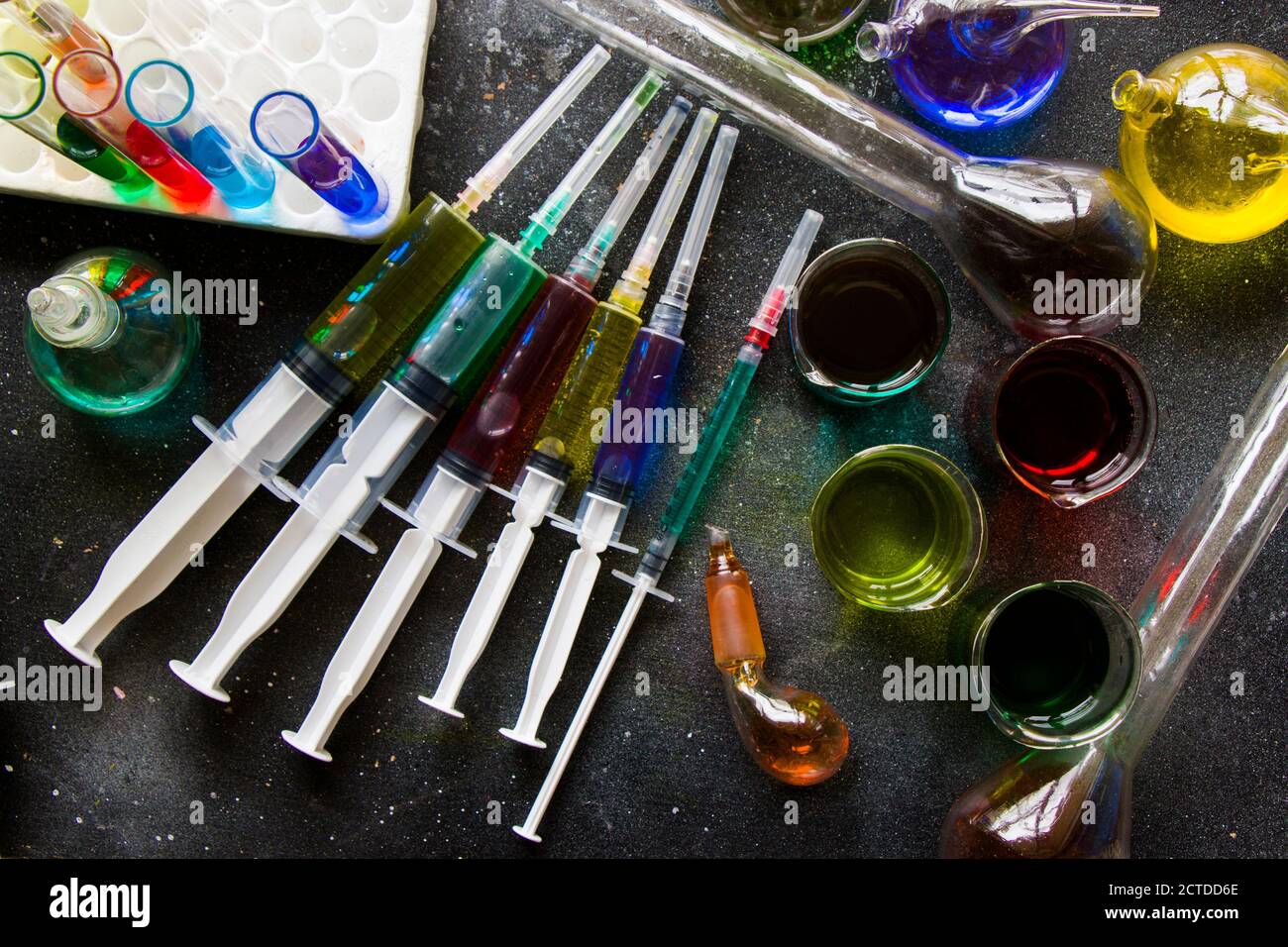 Multicolored and colorful medical needle and lab glassware with ...